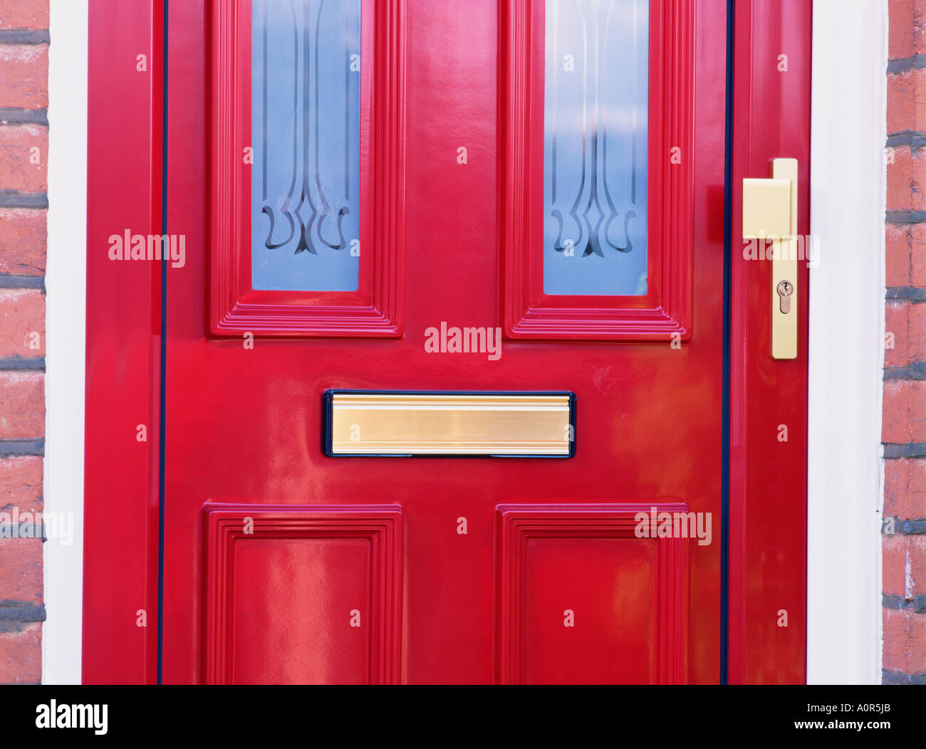 Architecture. Residential house. Glazed, red front door with letter box ...