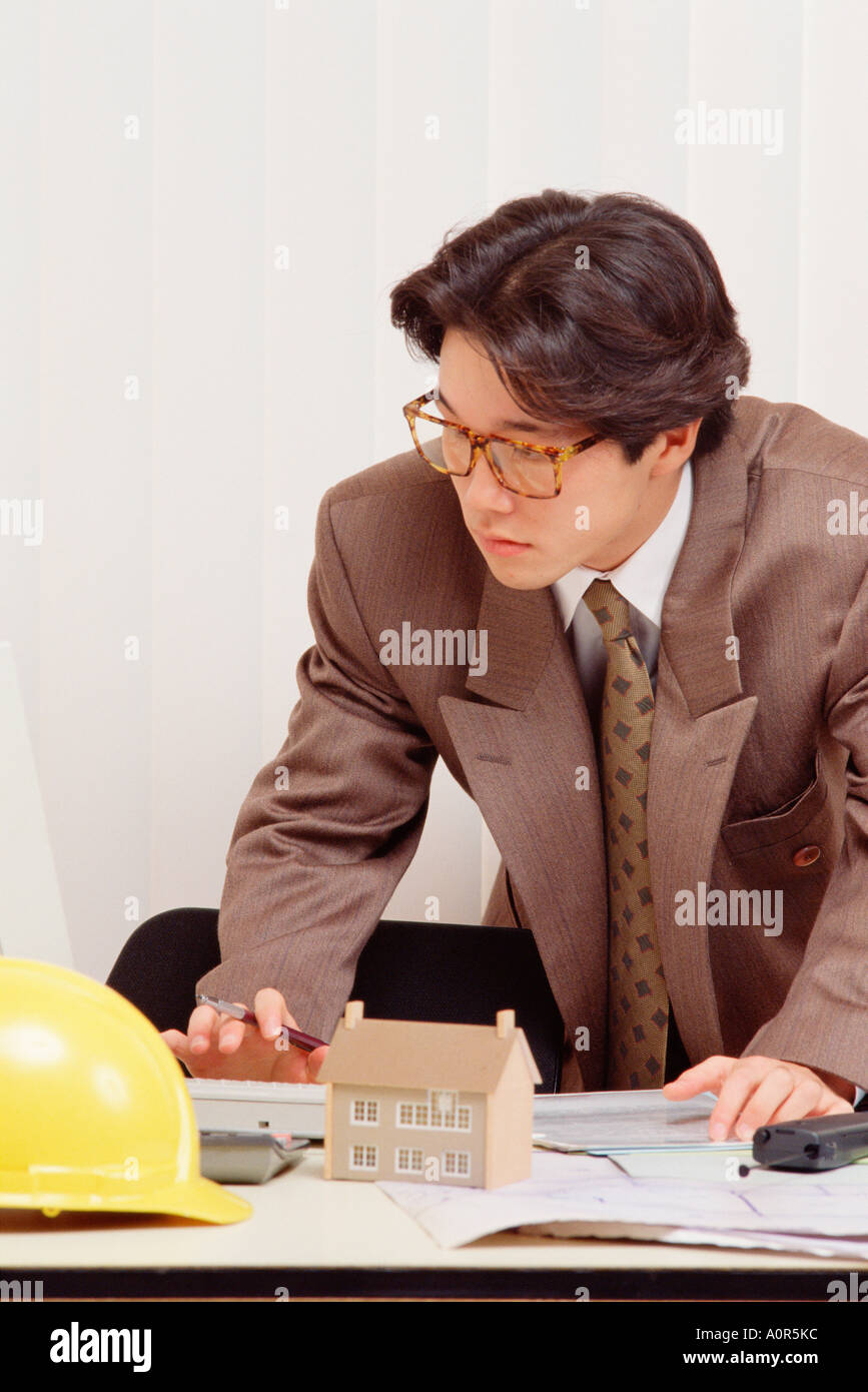 Japan. Young executive man standing by his desk Stock Photo - Alamy