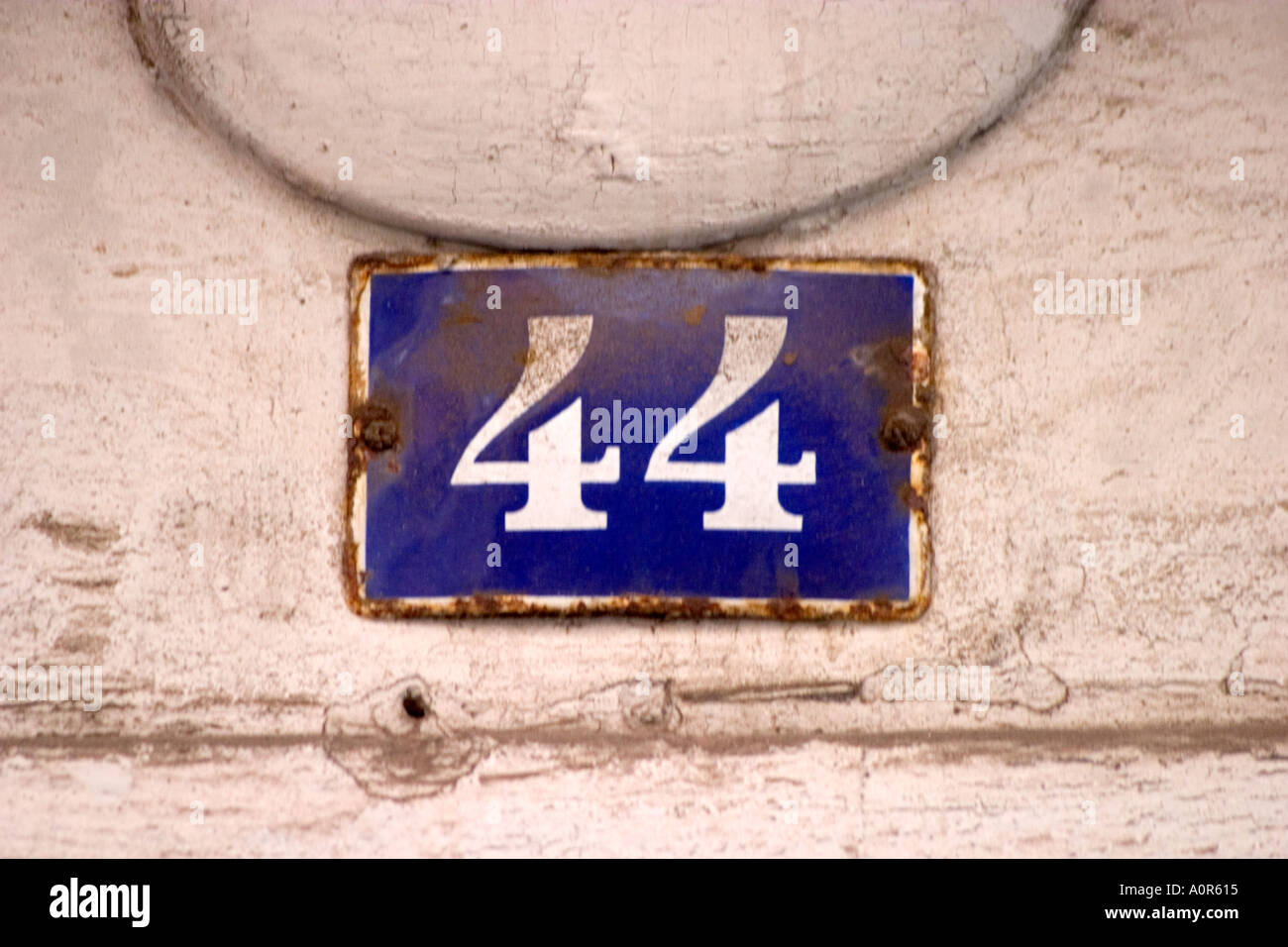 Old building with number "44" in blue varnished metal Stock Photo - Alamy