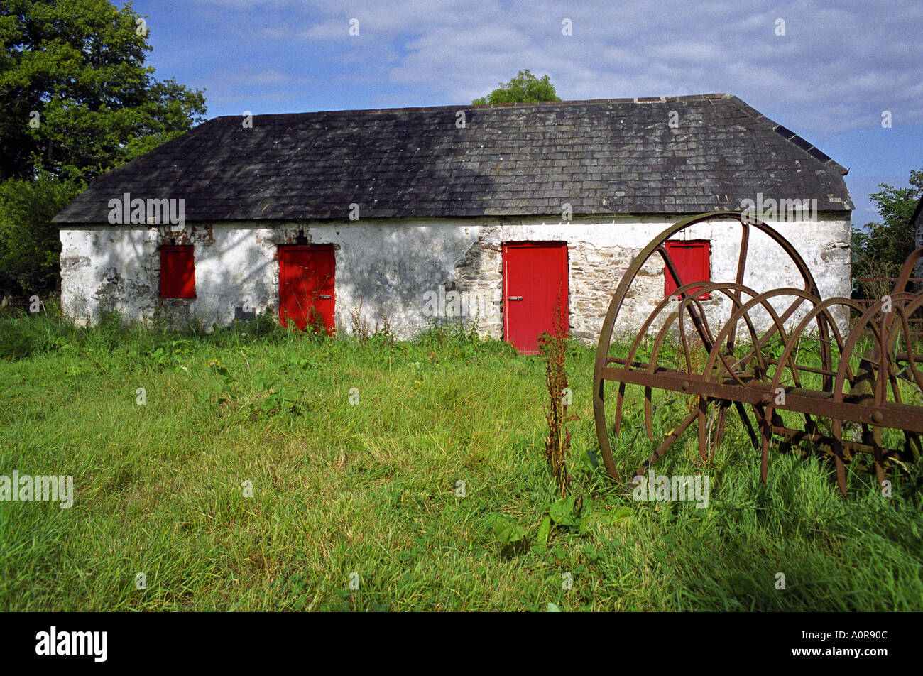 Rustic Irish Cattle Shed with rusty Threashing Machine Stock Photo - Alamy