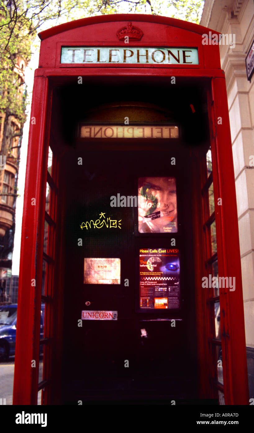 London phone box devoid of door and phone but intact with ads and ...
