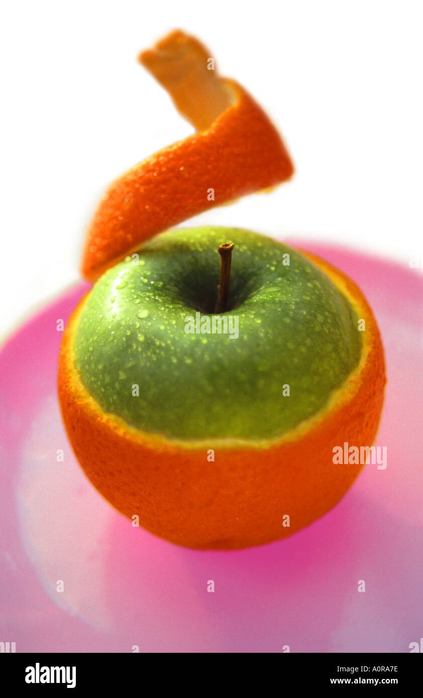 Half peeled orange revealing apple inside Stock Photo - Alamy
