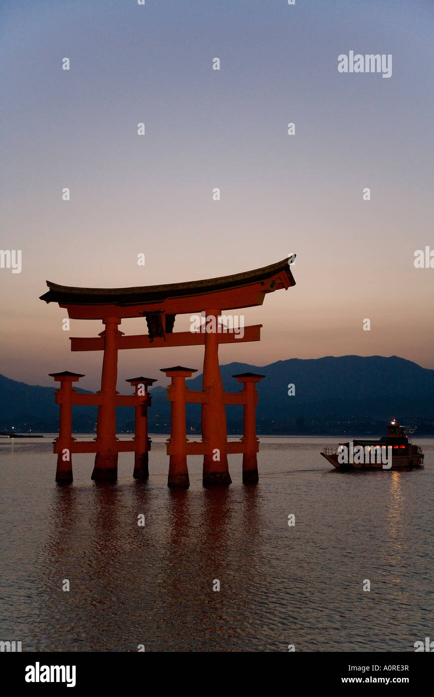 Vermillion coloured floating torii gate O torii gate illuminated at ...