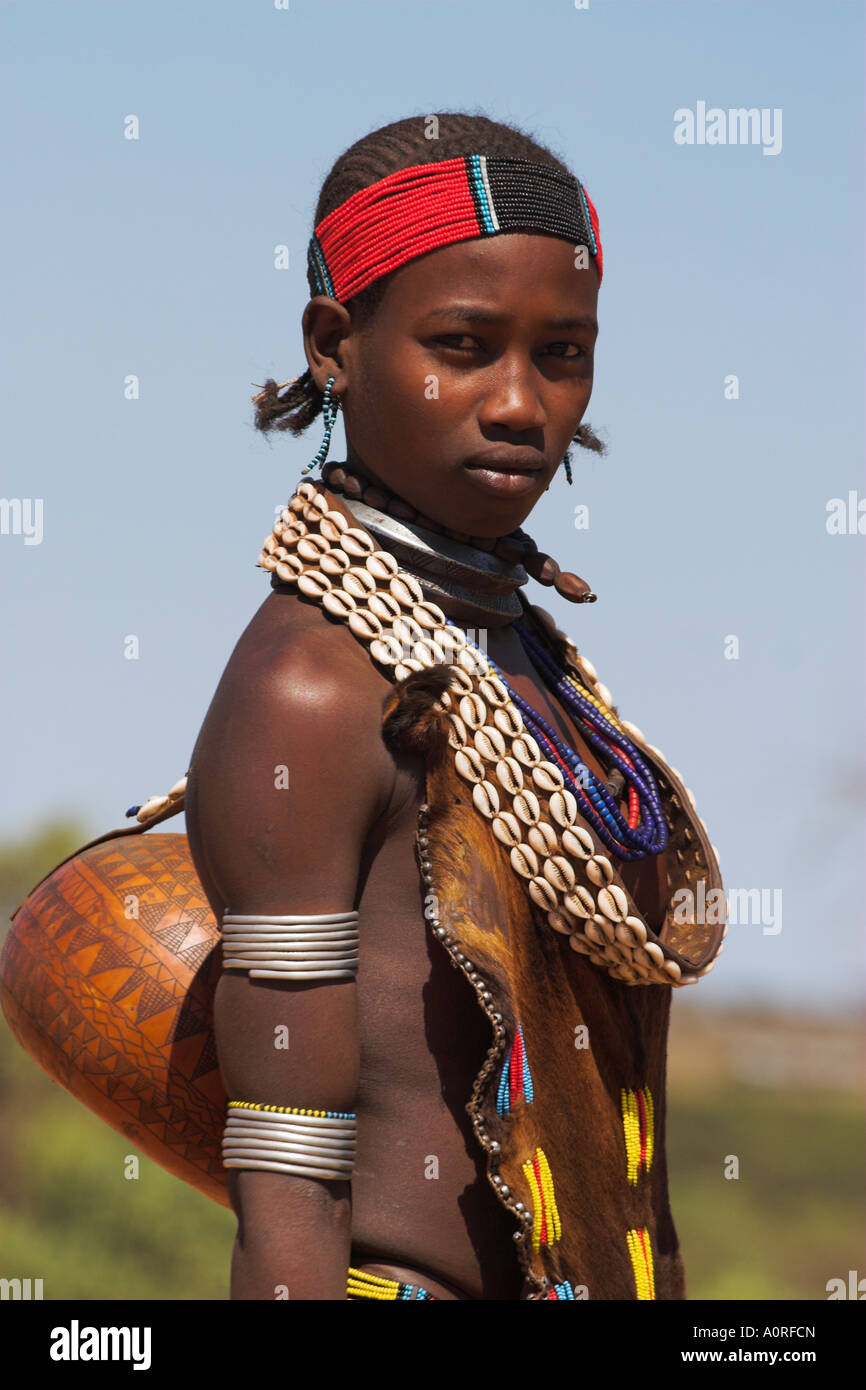 Hamer lady wearing traditional goat skin dress decorated with cowie ...