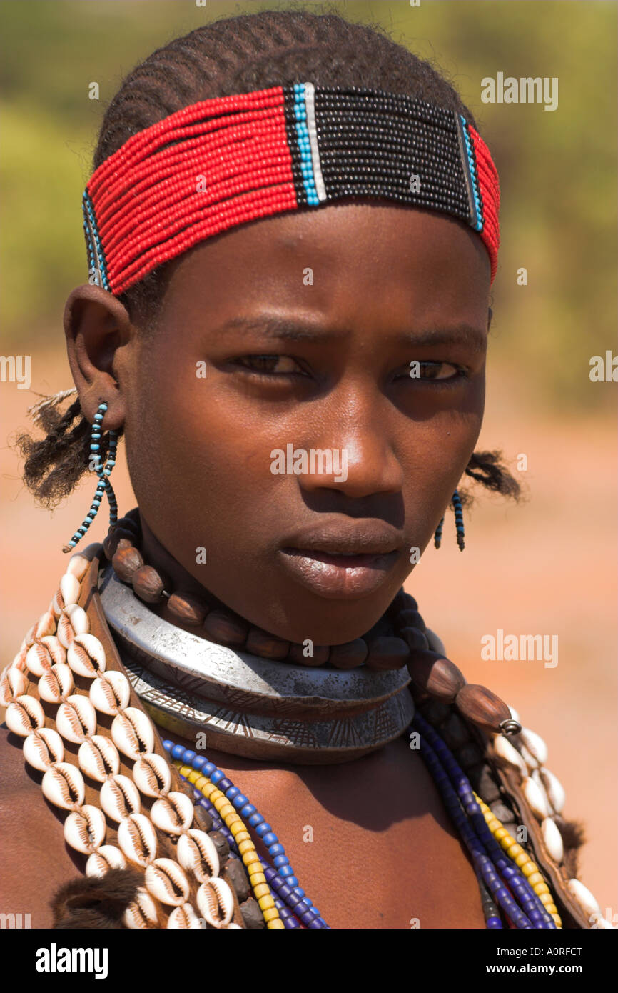 Hamer lady wearing traditional goat skin dress decorated with cowie ...