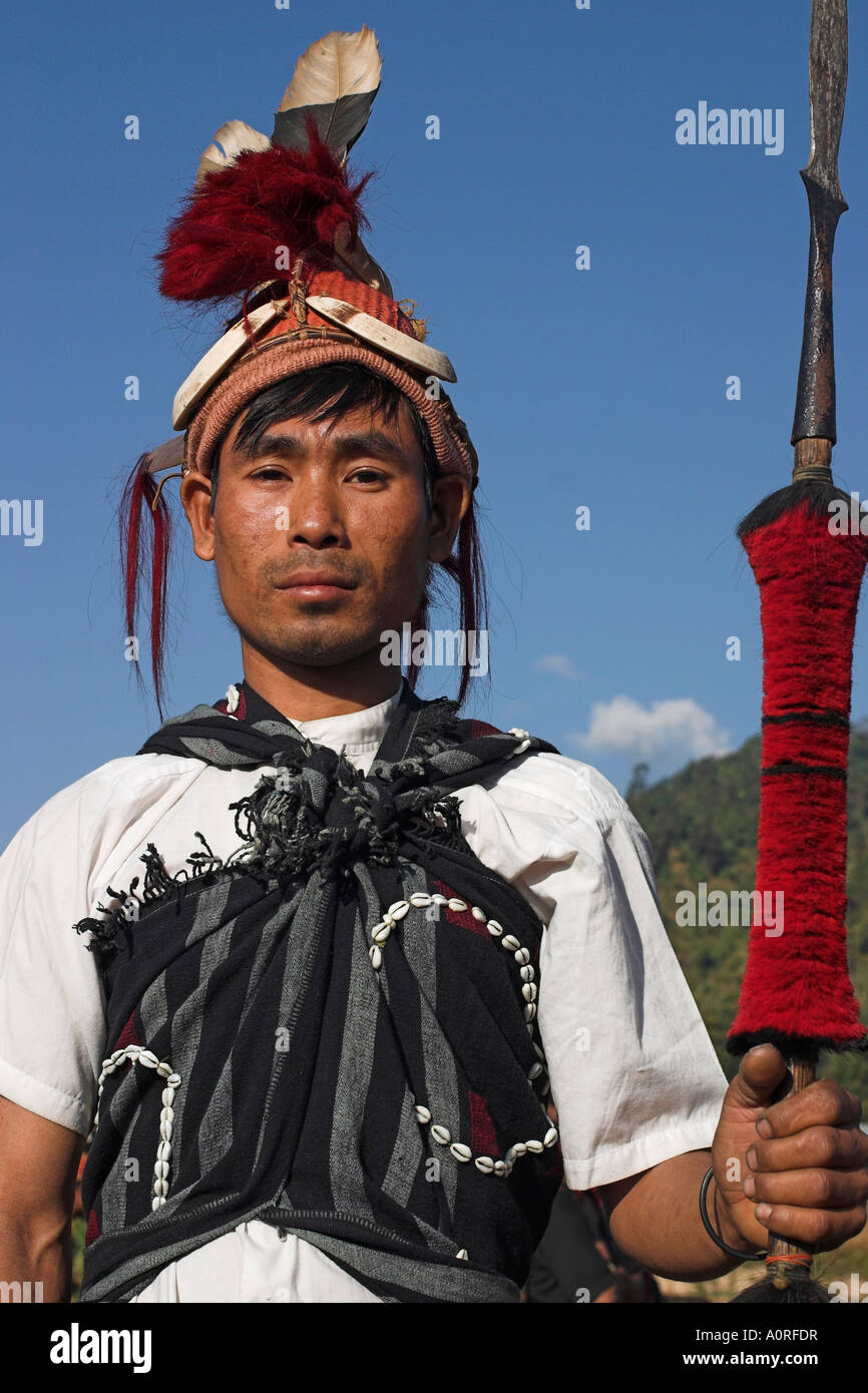 Naga man holding spear and wearing headdress of woven cane decorated ...
