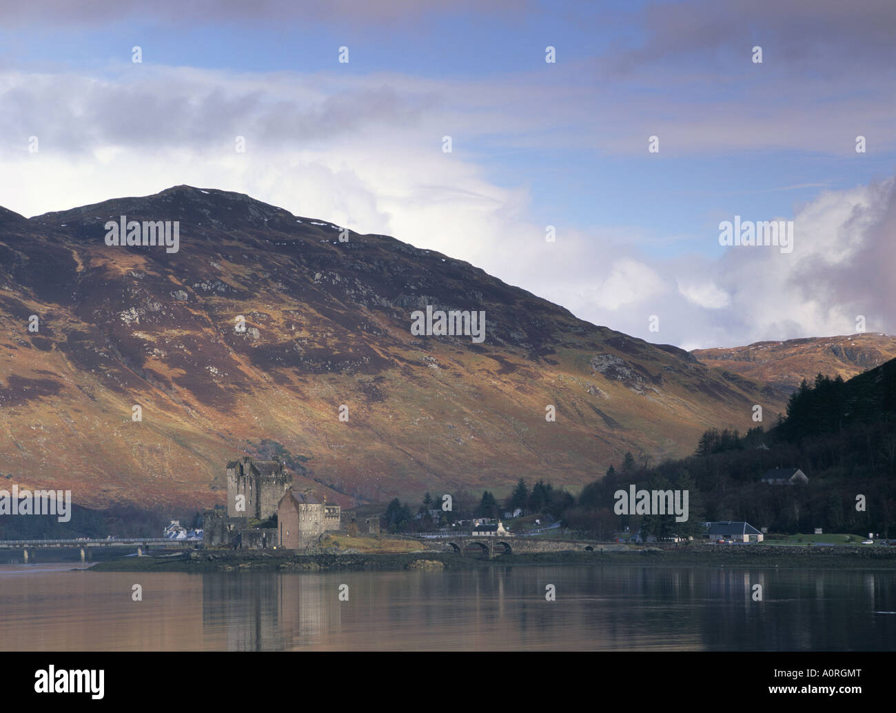 Eilean Donan castle reflected in the calm water of Loch Duich from ...