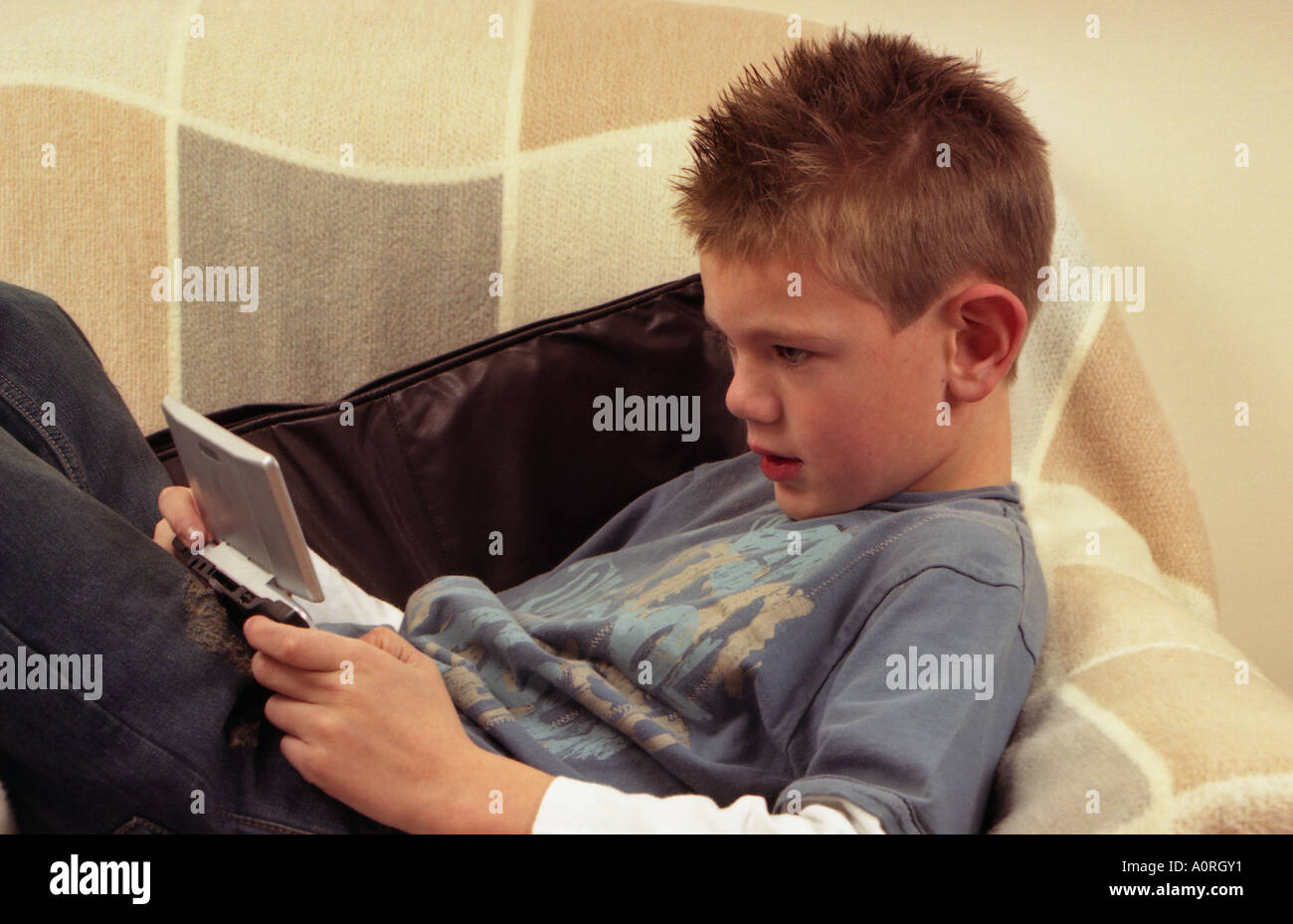 Boy playing gameboy hi-res stock photography and images - Alamy