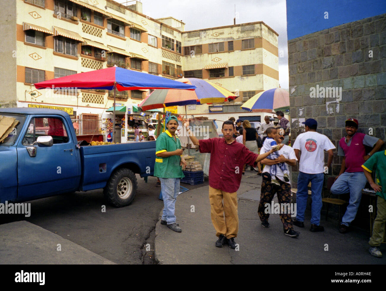 Group of men workers selling fruit & vegetables in busy animated ...