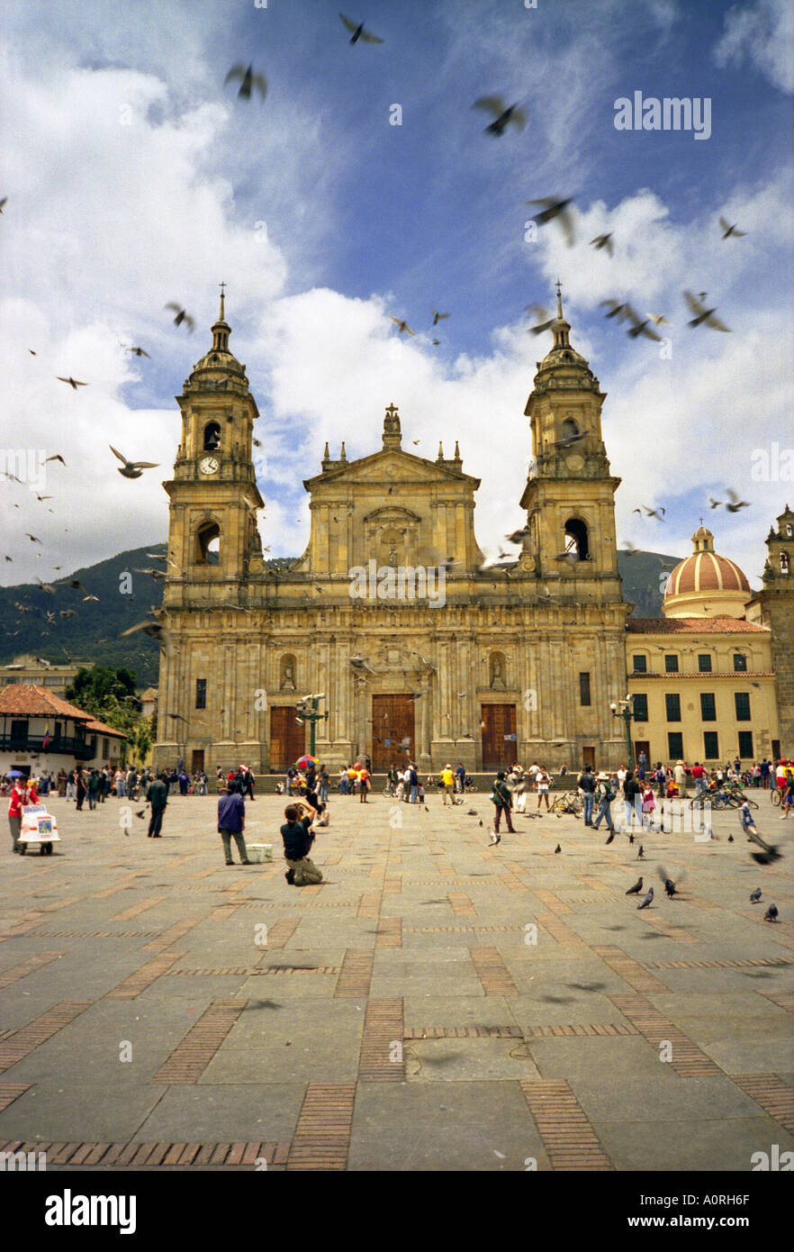 Bird pigeon fly over big imposing Catholic Church Cathedral busy square ...