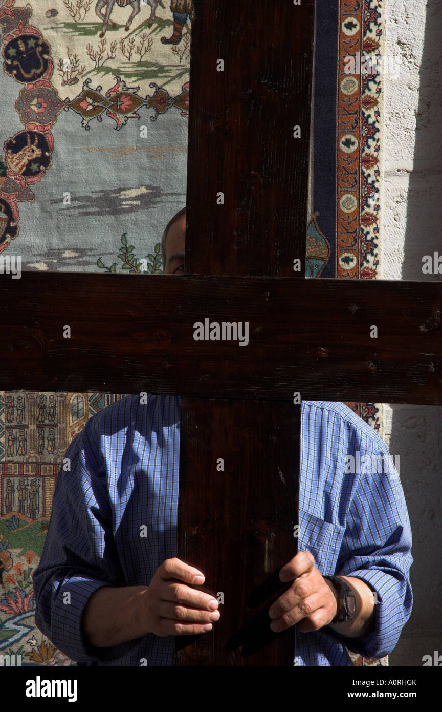 Male pilgrim holding cross at Station II on the Via Dolorosa during ...