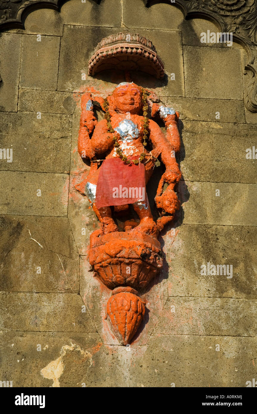 Hindu temple god on wall on banks of the Narmada River Maheshwar Madhya ...