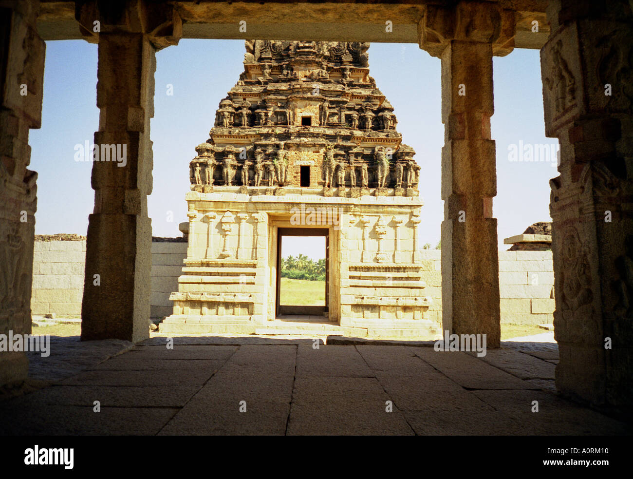Imposing monolithic rockwork entryway of Hindu temple seen through ...