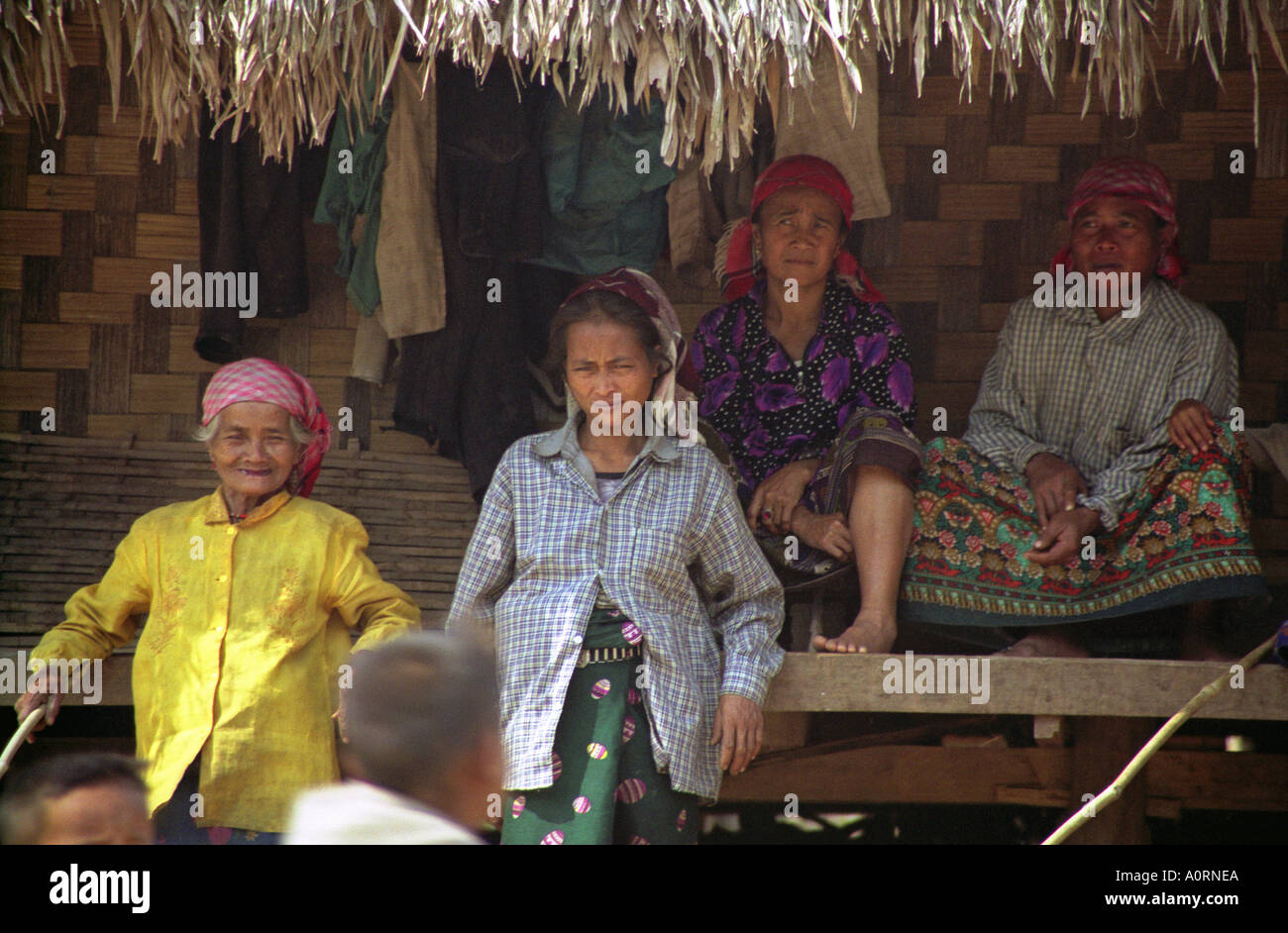 Group of indigenous women in colourful traditional clothing sitting in ...