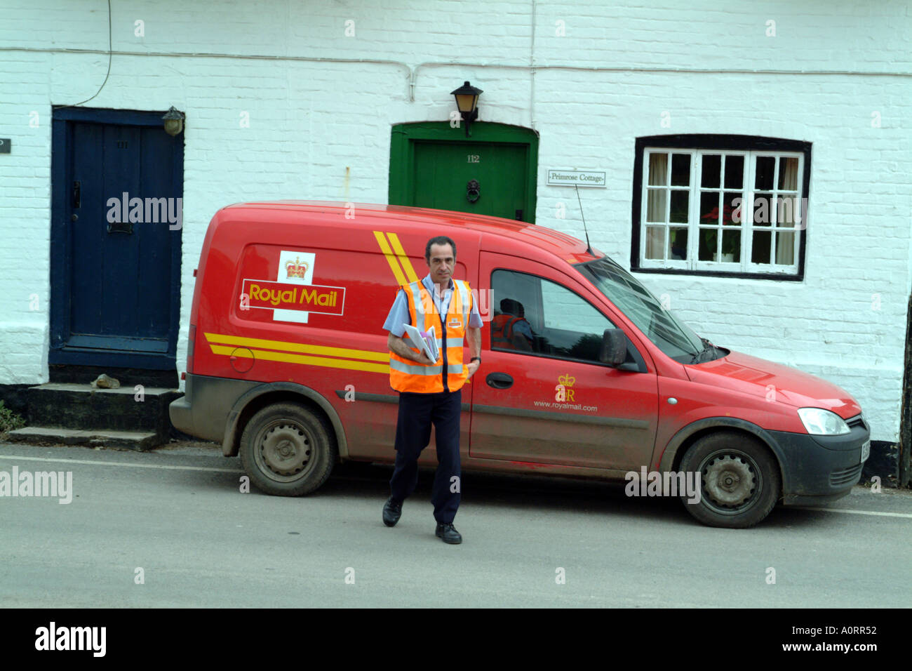 postman delivers letters in rural location England UK Royal Mail Stock ...