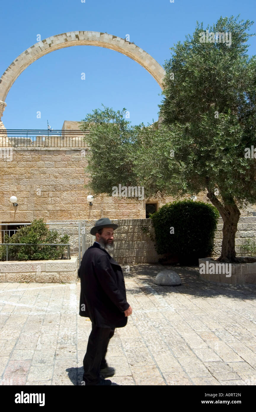 Jewish man in traditional clothes in front of the Hurva Synagogue arch ...