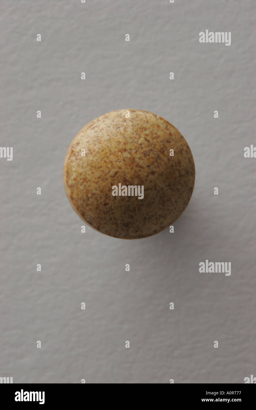 still life image of pill close up on a white background looking from ...