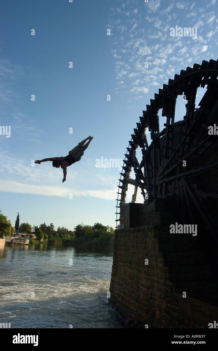 Man diving off water wheel Orontes River Hama Syria Middle East Stock ...
