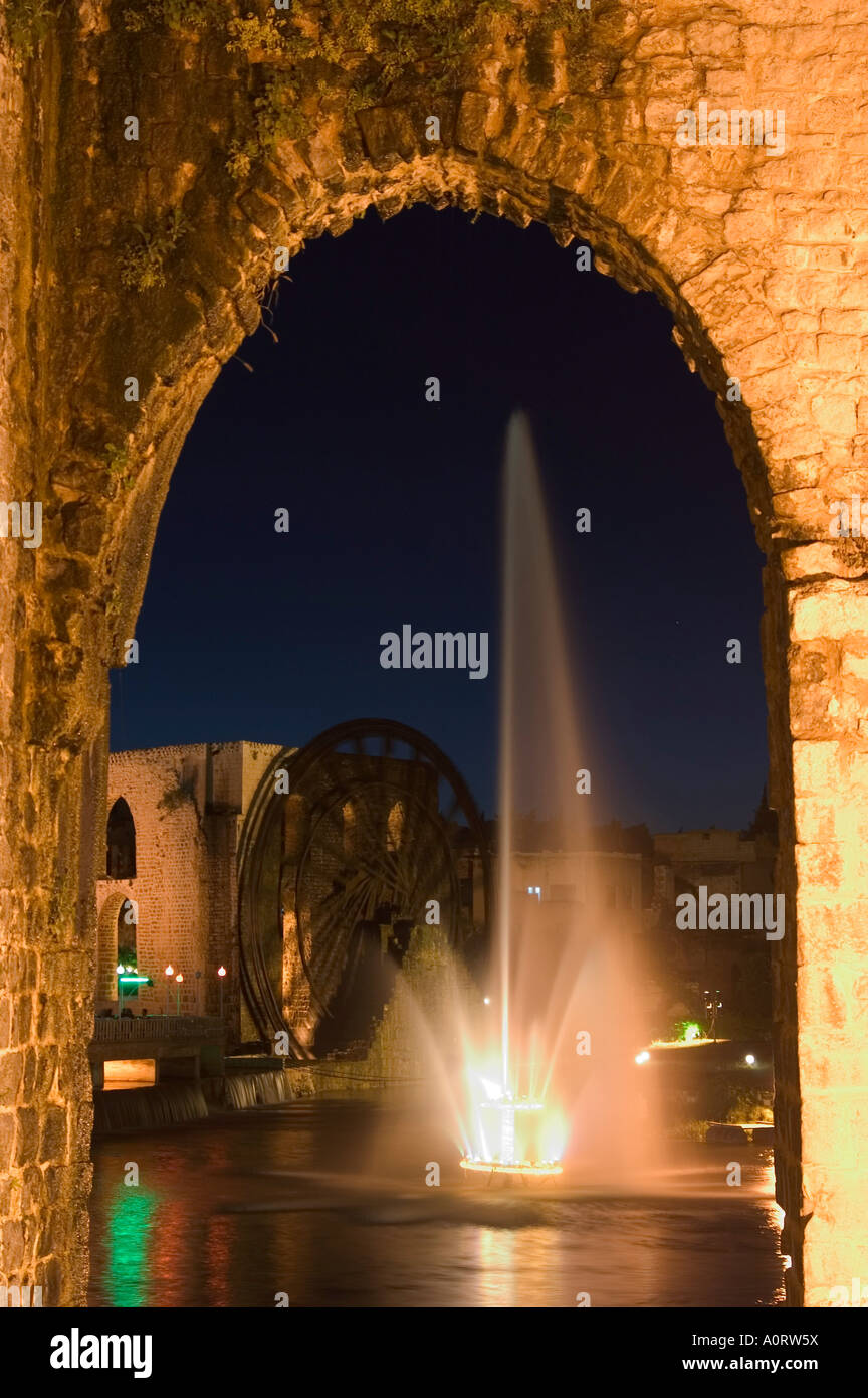 Fountain and water wheel on the Orontes River at night Hama Syria ...
