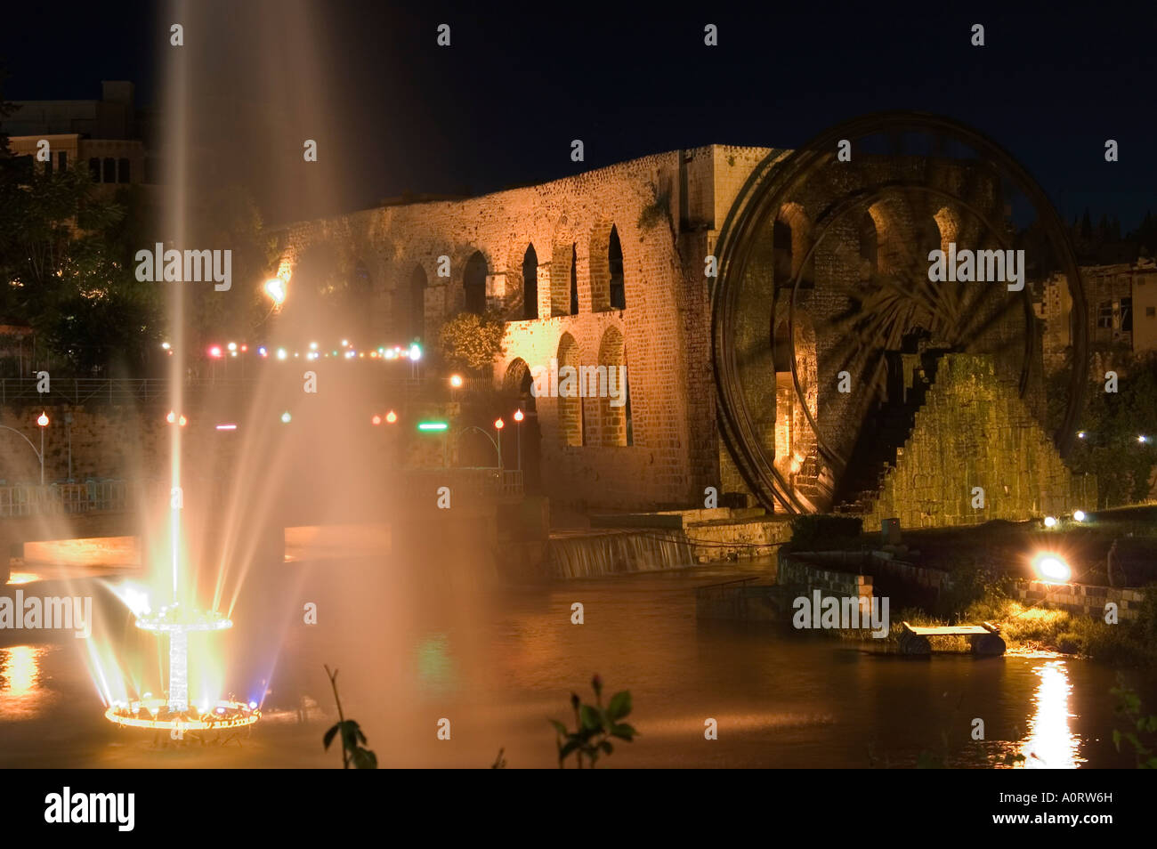 Fountain and water wheel on the Orontes River at night Hama Syria ...