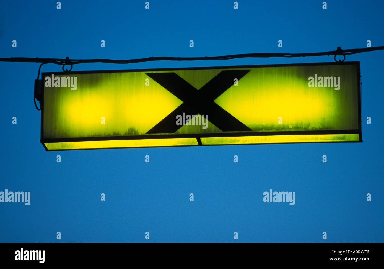 Glowing yellow overhead pedestrian crossing sign with a single x Stock ...