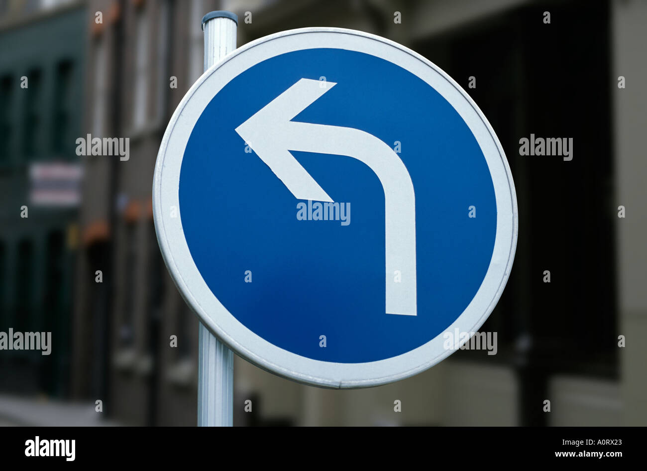 Cars and automobiles must turn left ahead sign Stock Photo - Alamy