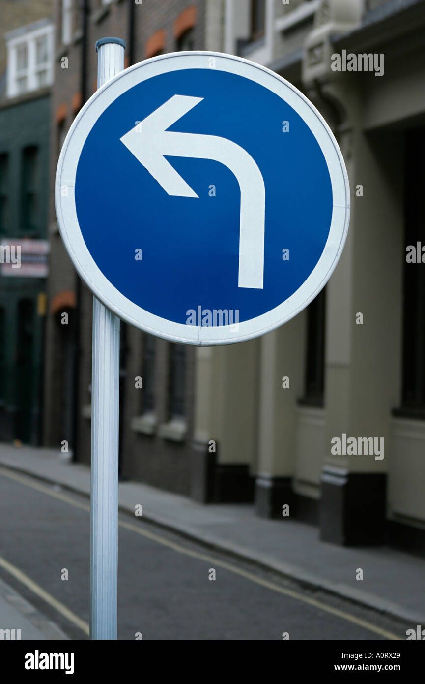 Cars and automobiles must turn left ahead sign Stock Photo - Alamy