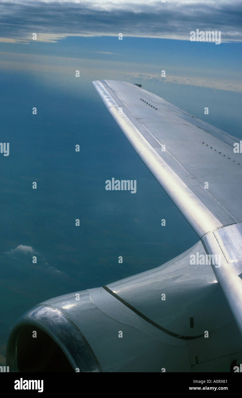 In cabin view of a portion of wing and jet engine of a commercial jet ...