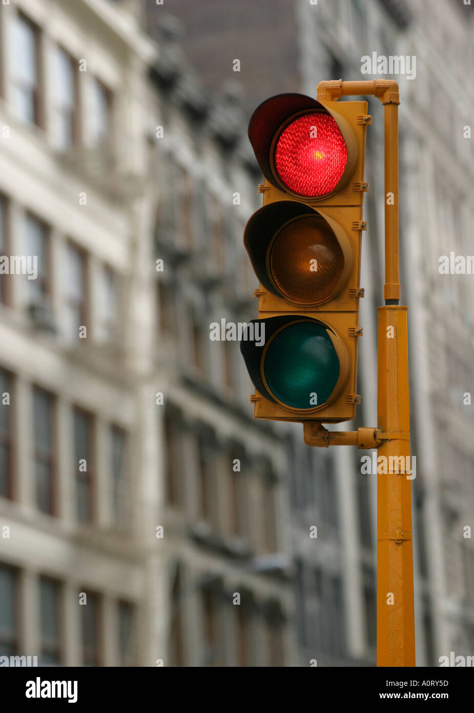 Vertical traffic light with red light signal illuminated or lit and ...