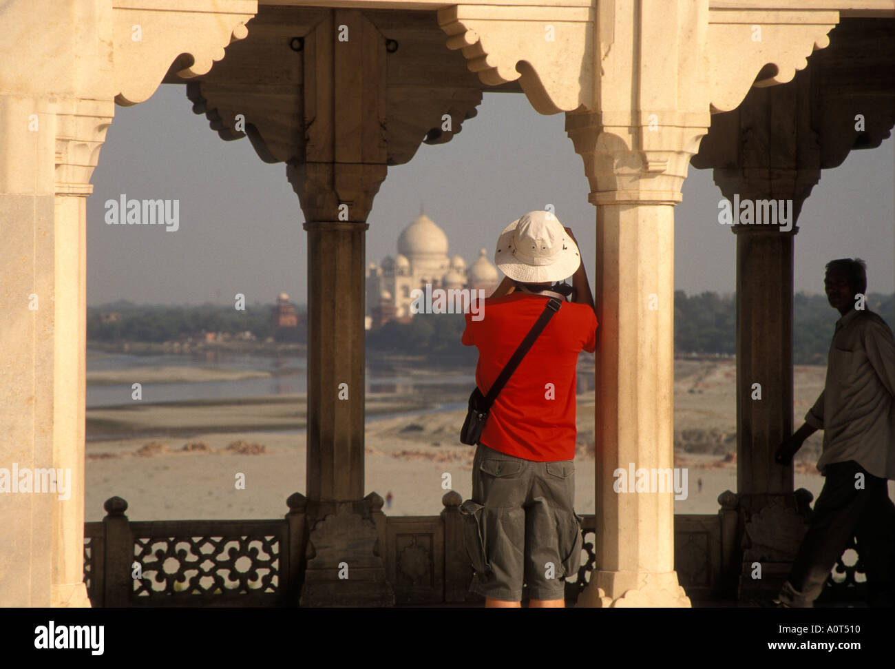 Tourist in taj like hat at Agra Fort Taj Mahal in background India ...