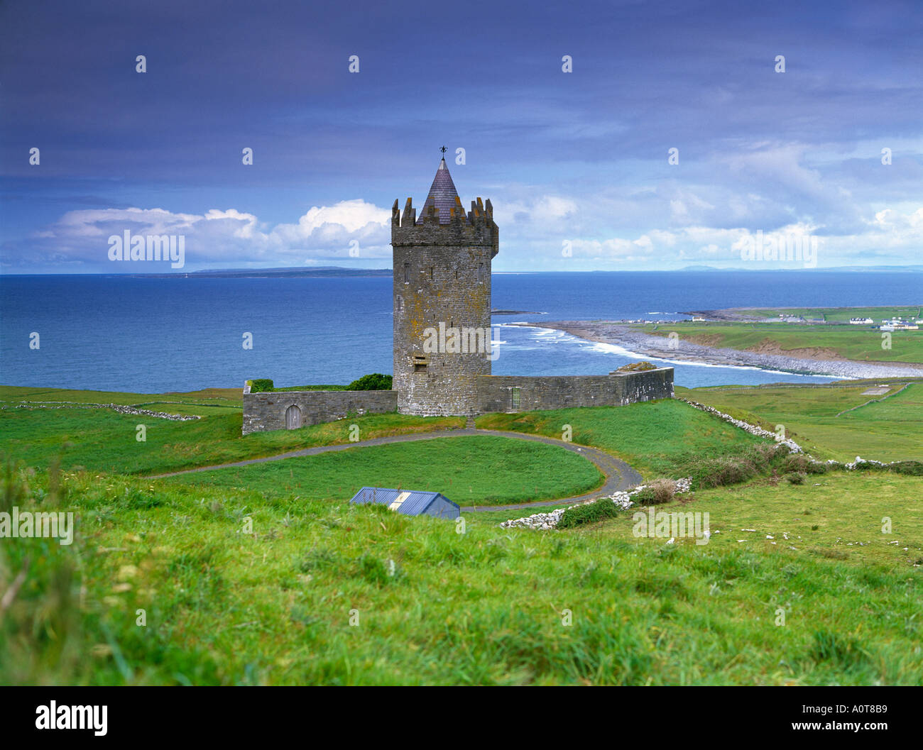 large round castle overlooking the atlantic ocean, county clare, wild ...