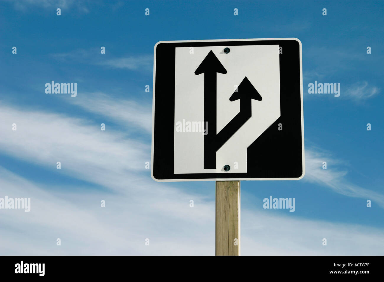 Sign indicating road or highway divides into two lanes Stock Photo - Alamy
