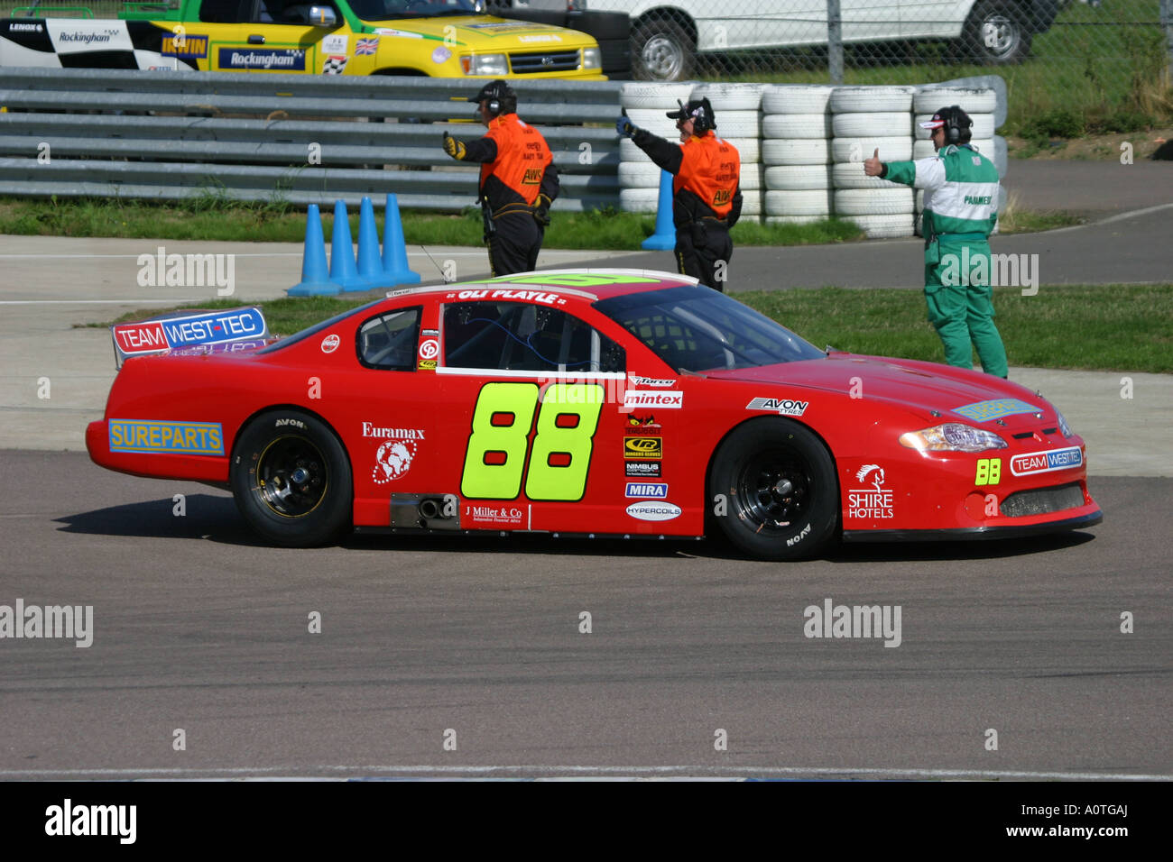 V8 Nascar type stock cars racing on a banked oval circuit Stock Photo ...