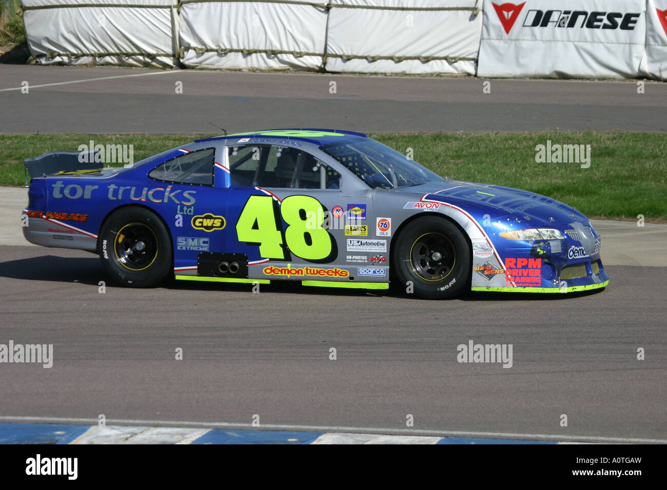 V8 Nascar type stock cars racing on a banked oval circuit Stock Photo ...