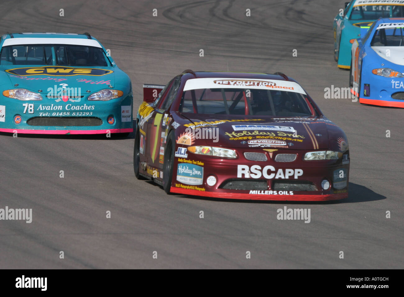 V8 Nascar type stock cars racing on a banked oval circuit Stock Photo ...