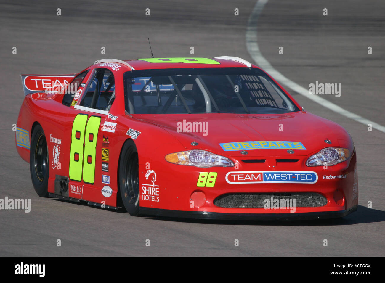 V8 Nascar type stock cars racing on a banked oval circuit Stock Photo ...
