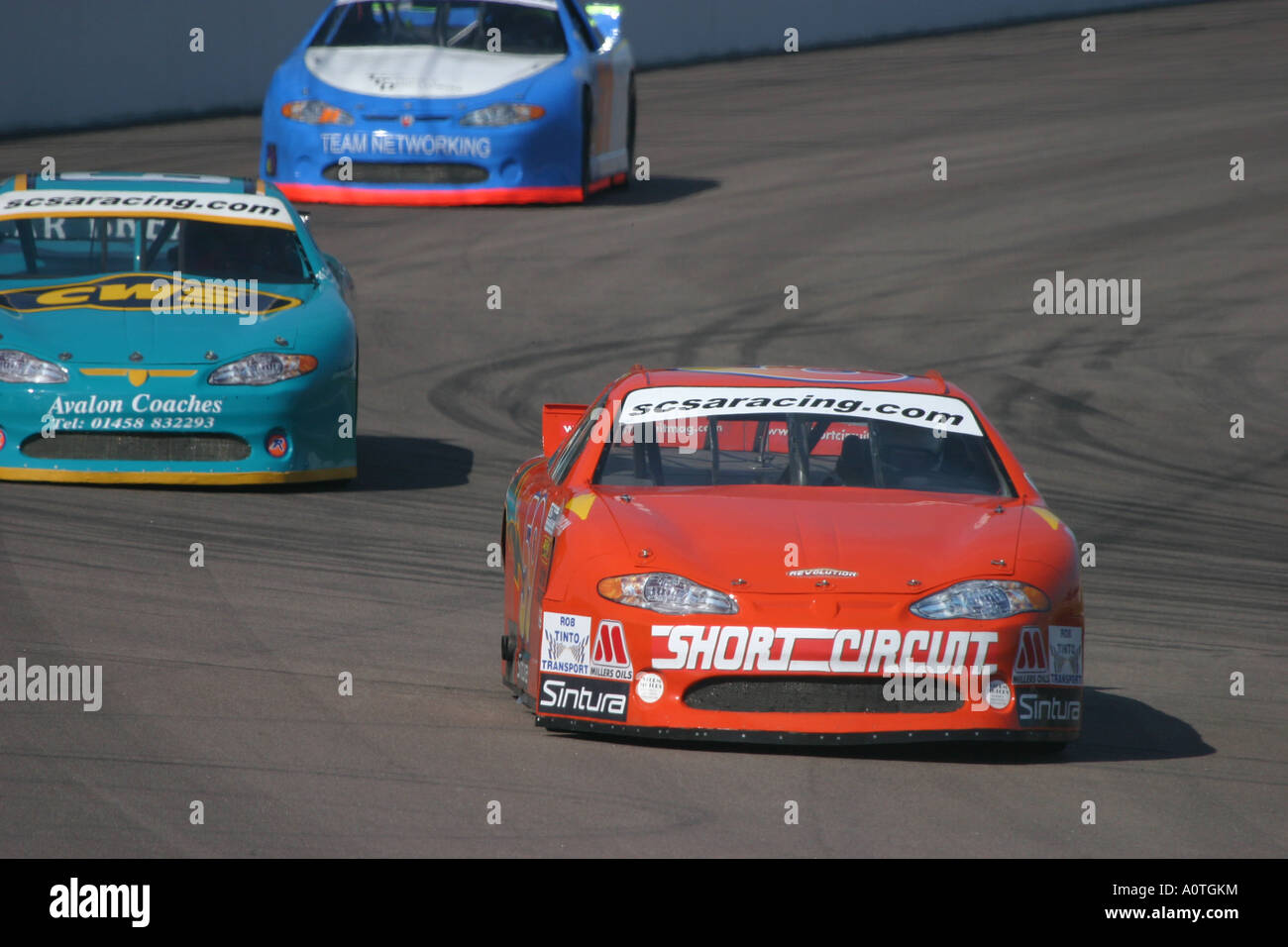 V8 Nascar type stock cars racing on a banked oval circuit Stock Photo ...