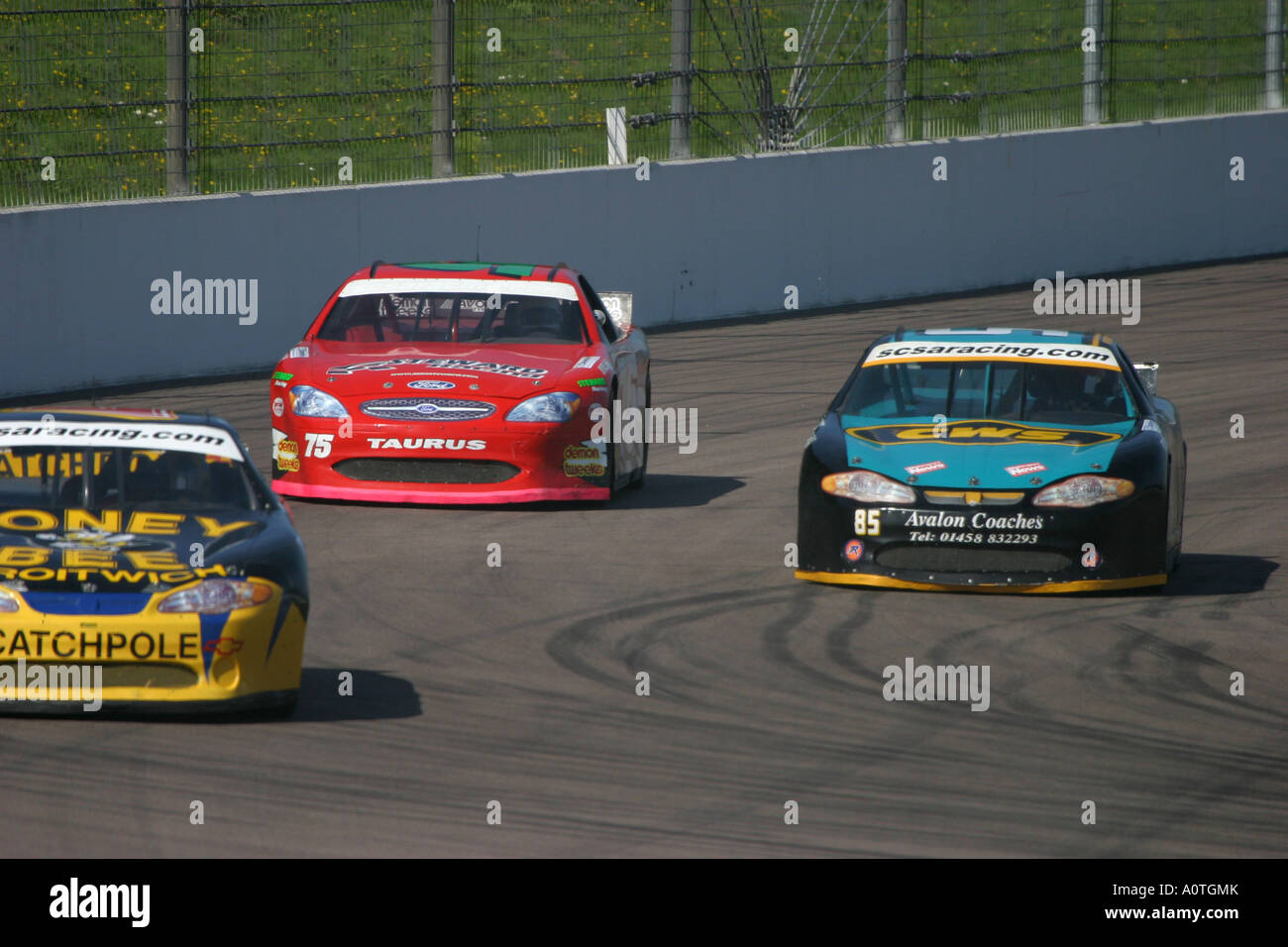 V8 Nascar type stock cars racing on a banked oval circuit Stock Photo ...