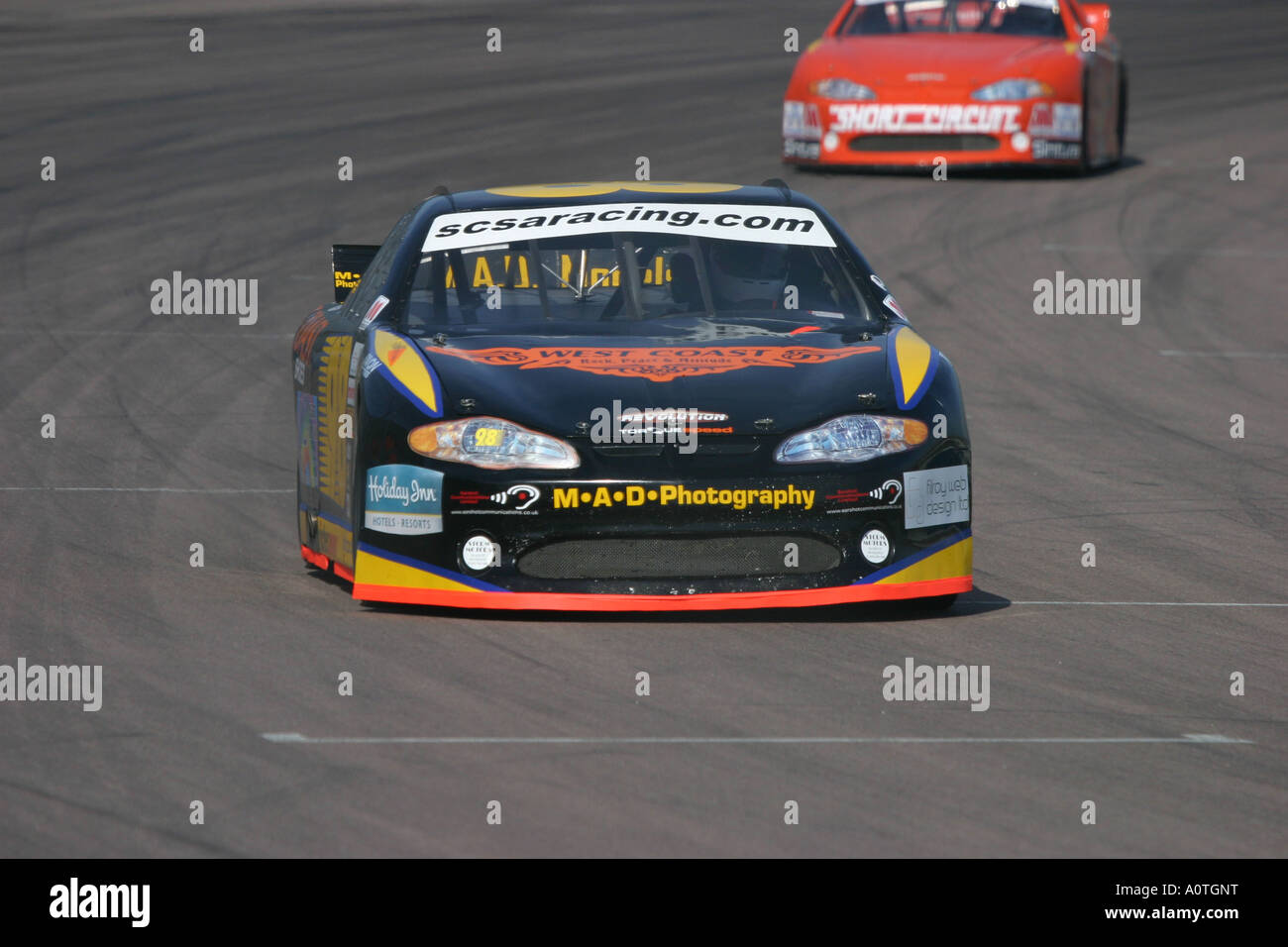 V8 Nascar type stock cars racing on a banked oval circuit Stock Photo ...