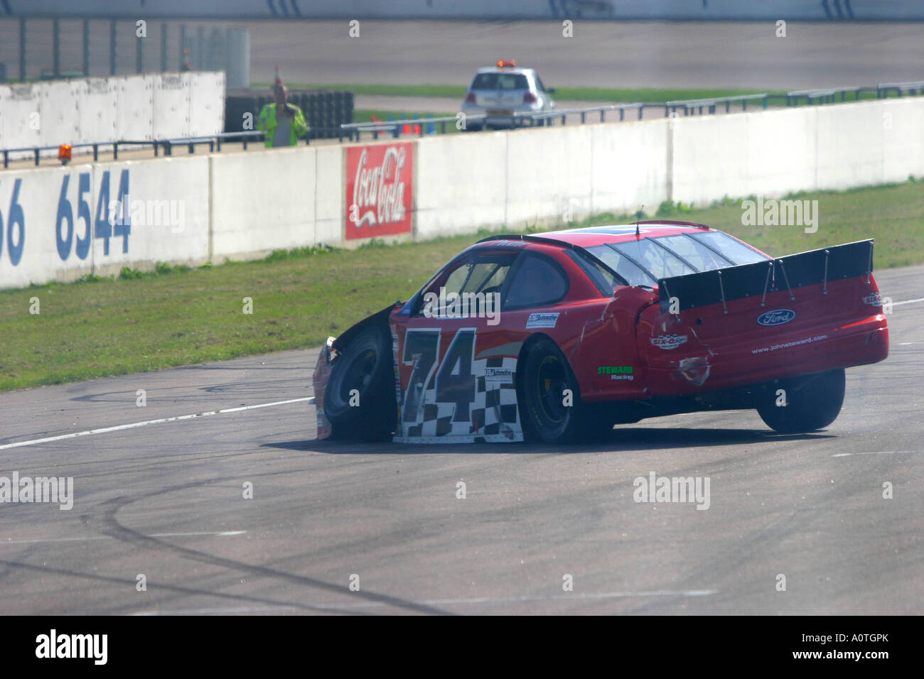 V8 Nascar being attended to by safety crew after crashing Stock Photo ...