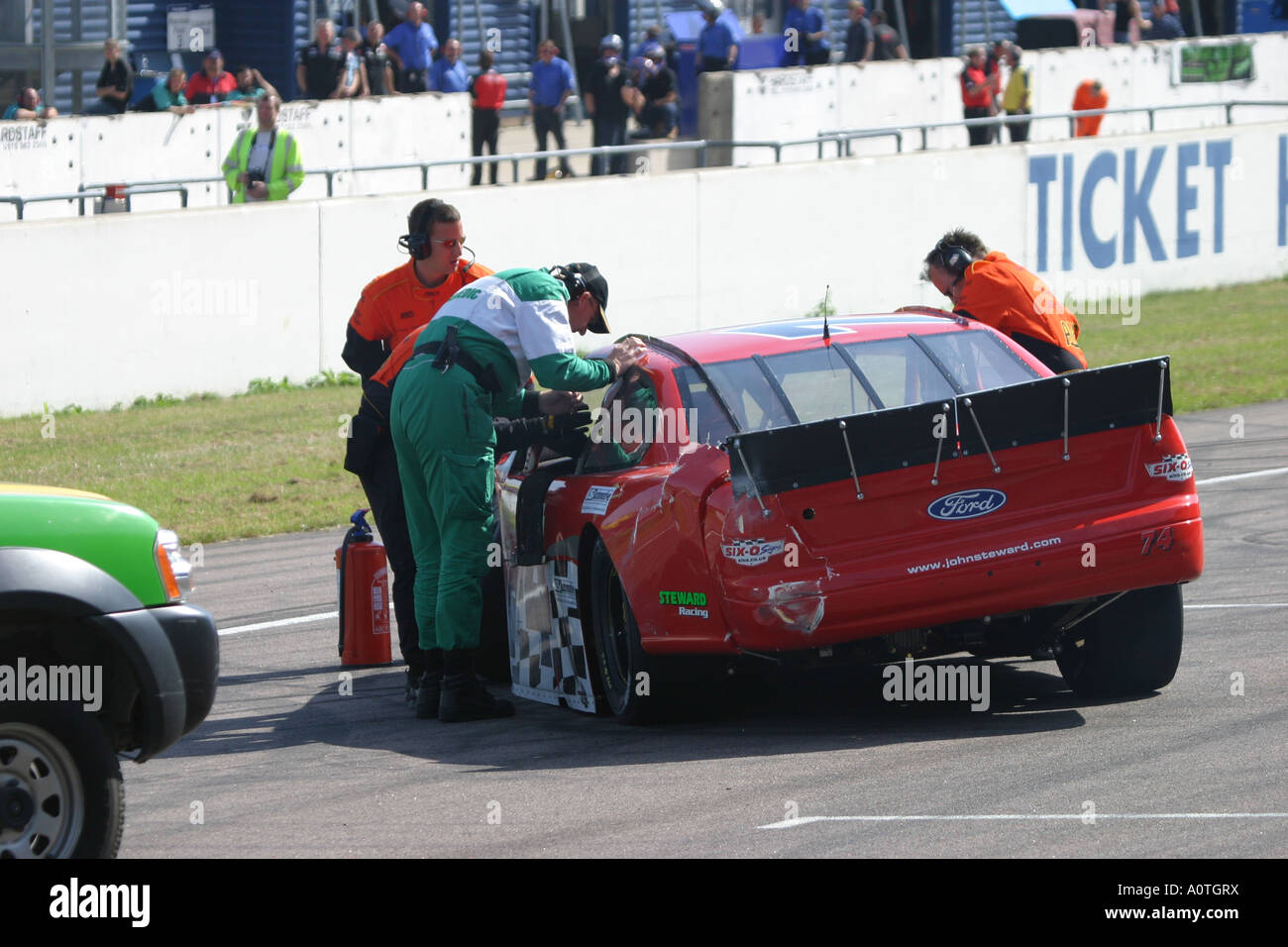 V8 Nascar being attended to by safety crew after crashing Stock Photo ...