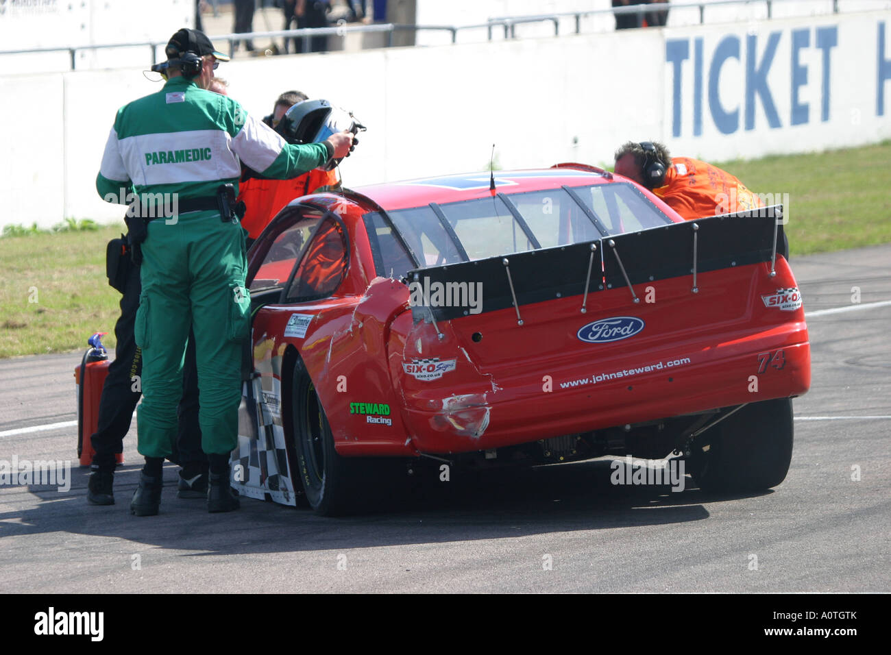 V8 Nascar being attended to by safety crew after crashing Stock Photo ...