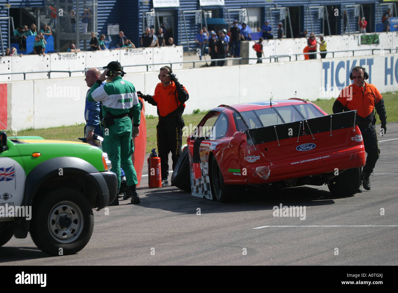V8 Nascar being attended to by safety crew after crashing Stock Photo ...