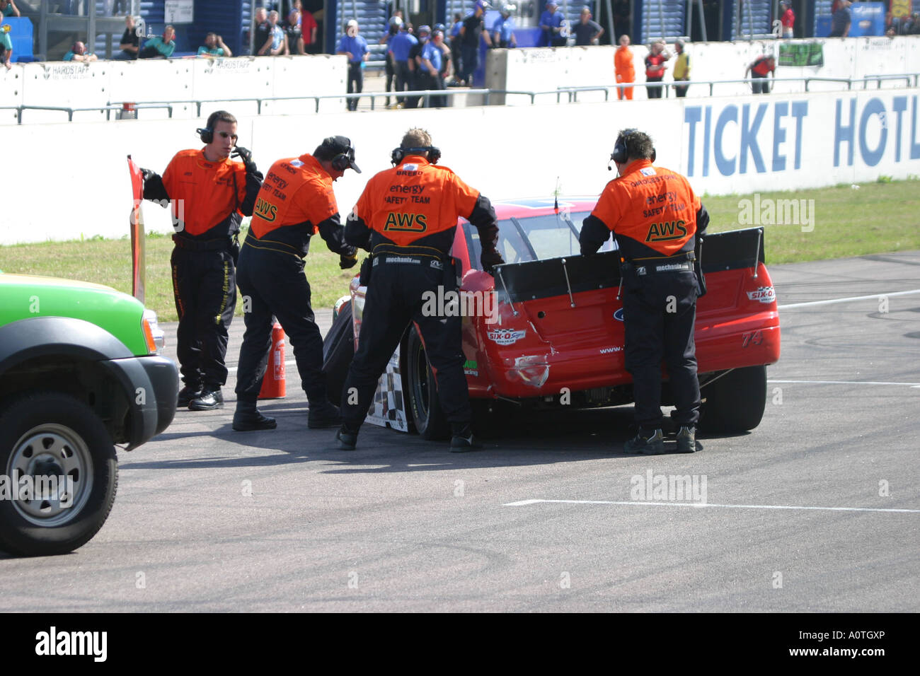 V8 Nascar being attended to by safety crew after crashing Stock Photo ...
