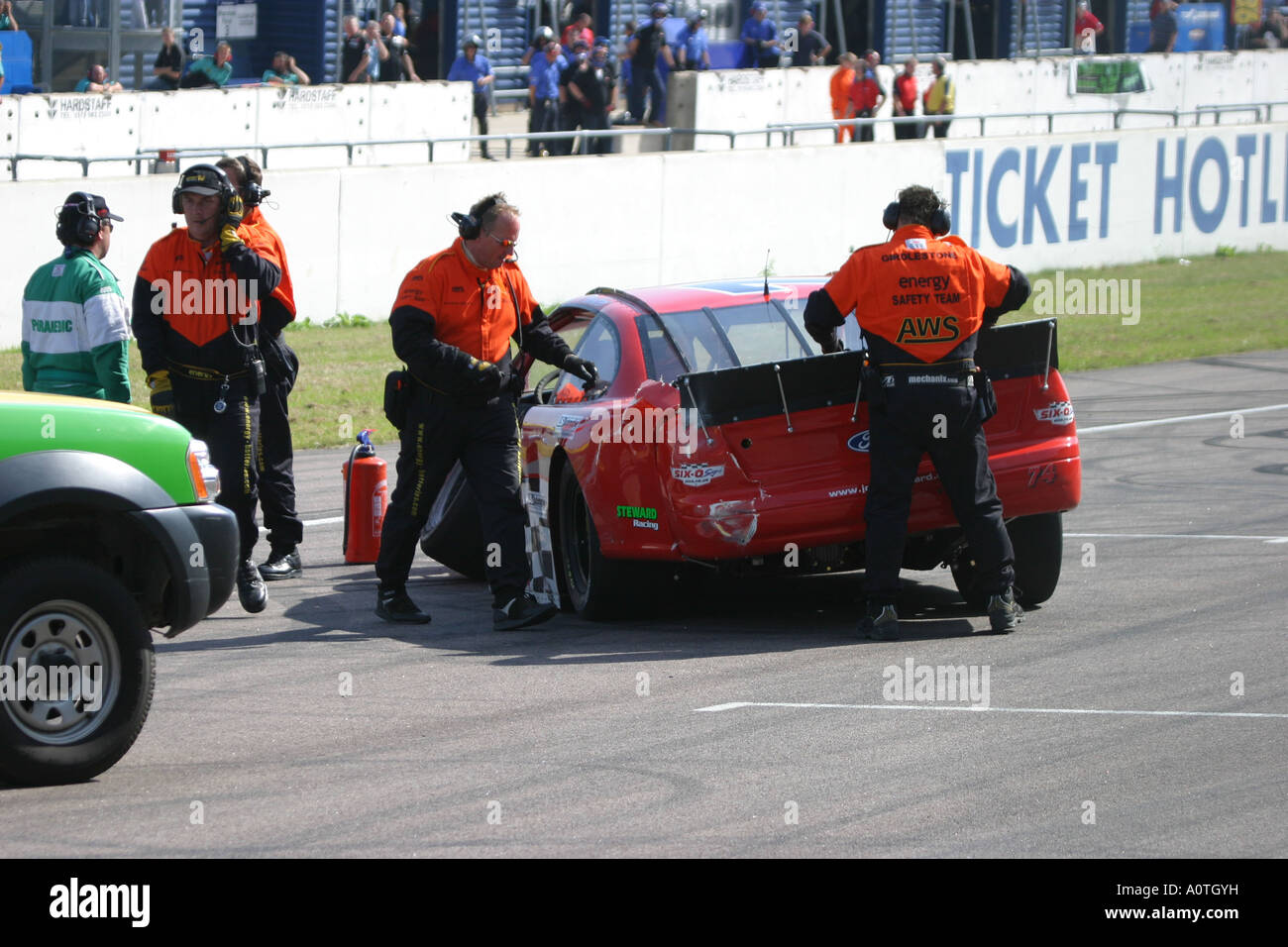 V8 Nascar being attended to by safety crew after crashing Stock Photo ...
