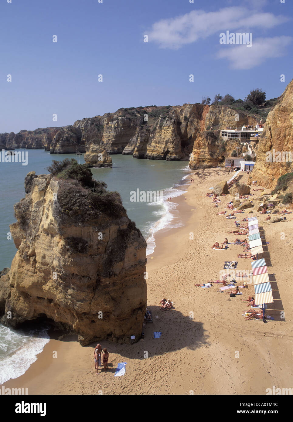 Algarve Praia Da Dona Ana sandy beach and shoreline sun shade parasoles ...