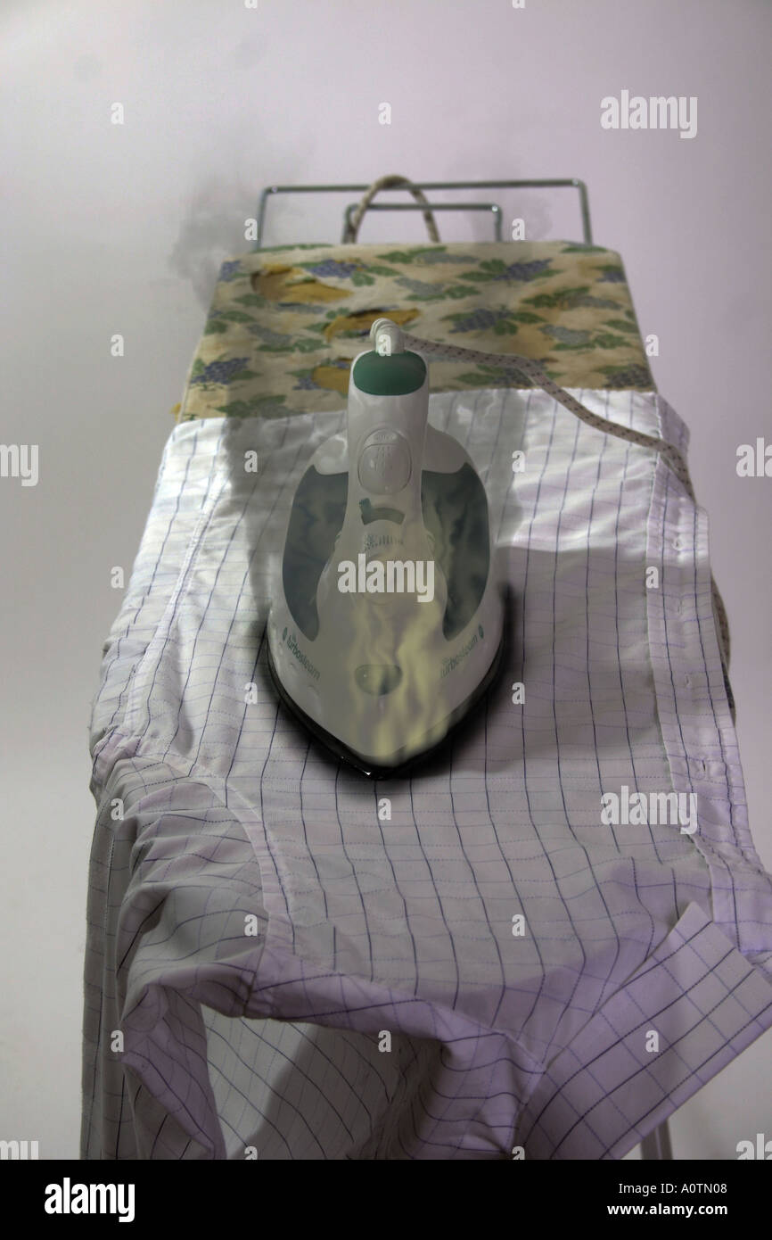 Iron left on shirt causing it to burn with smoke Stock Photo - Alamy