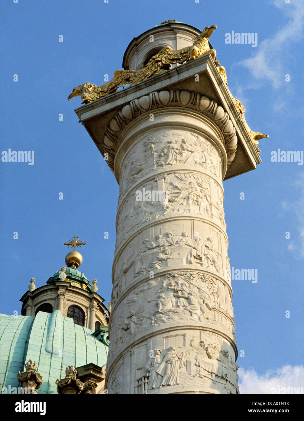 Looking up at the ornate spirally decorated carved pillar with people ...