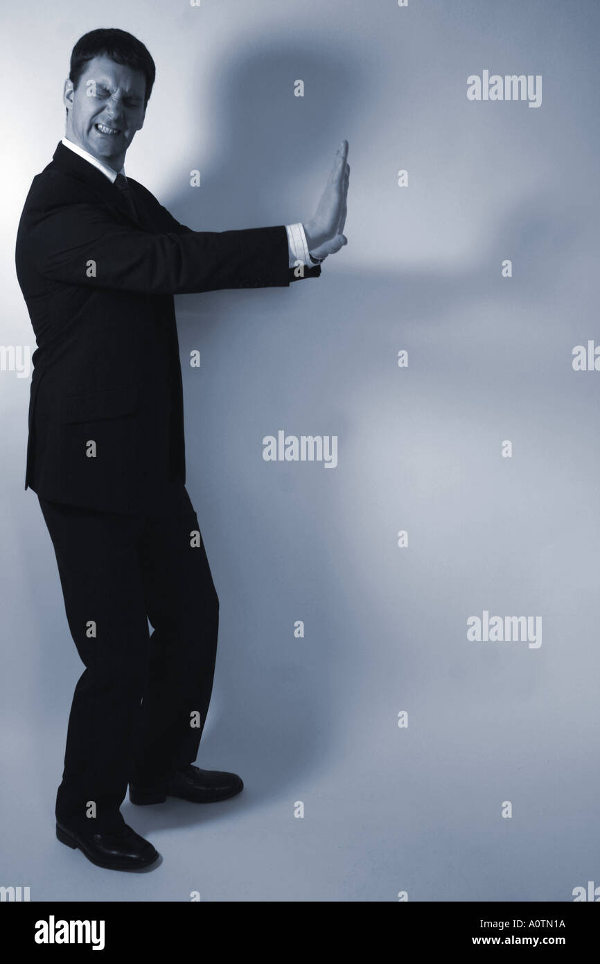 Conceptual image showing business man pushing something which is not ...