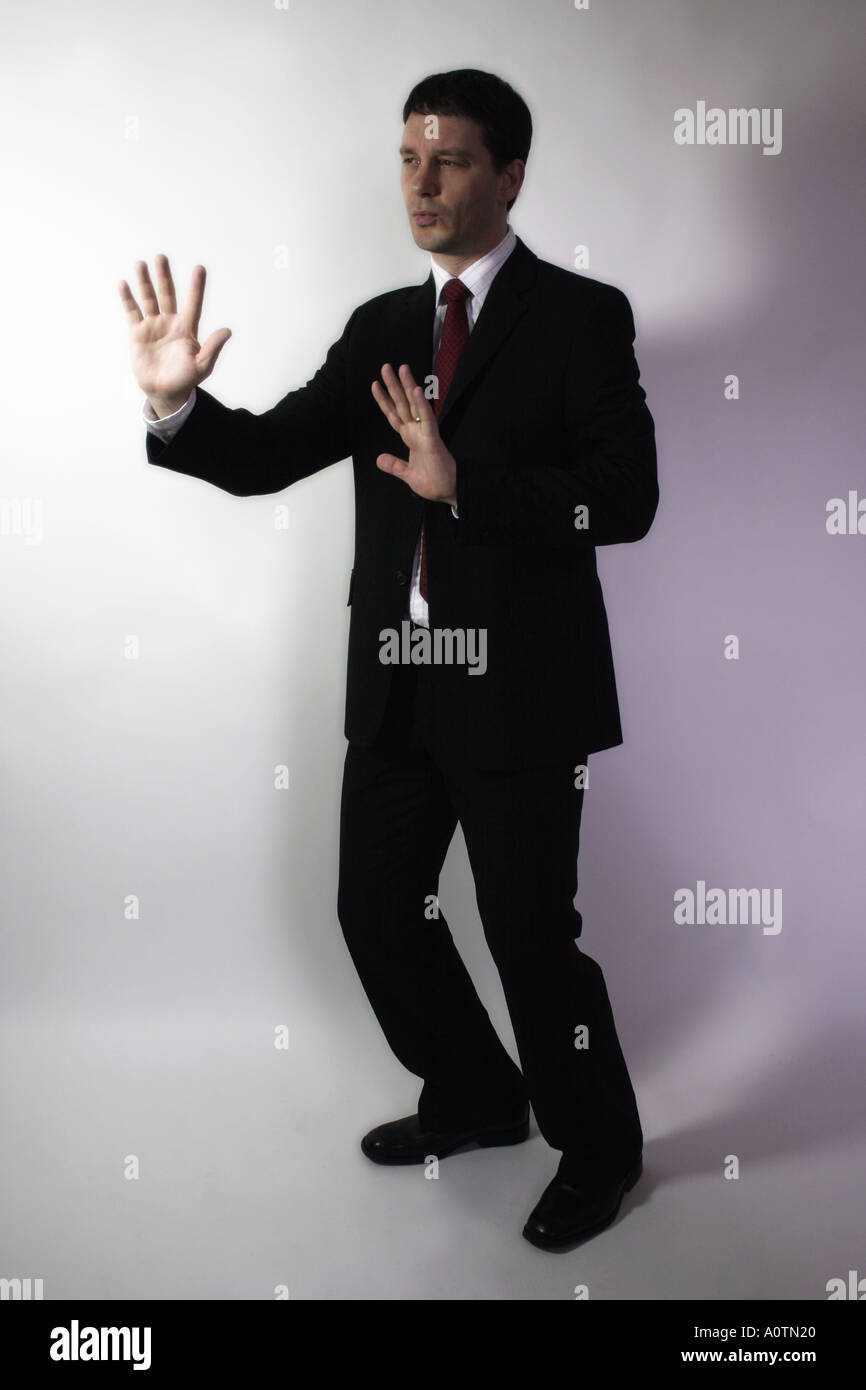 Business man in suit practices tai chi to relax Stock Photo - Alamy